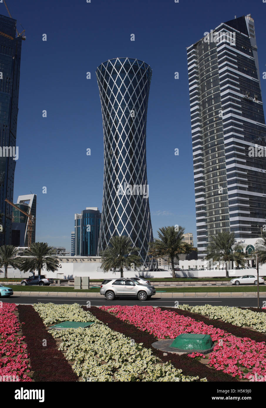 Tornado Tower skyscraper and flower beds along the roadside, West Bay ...