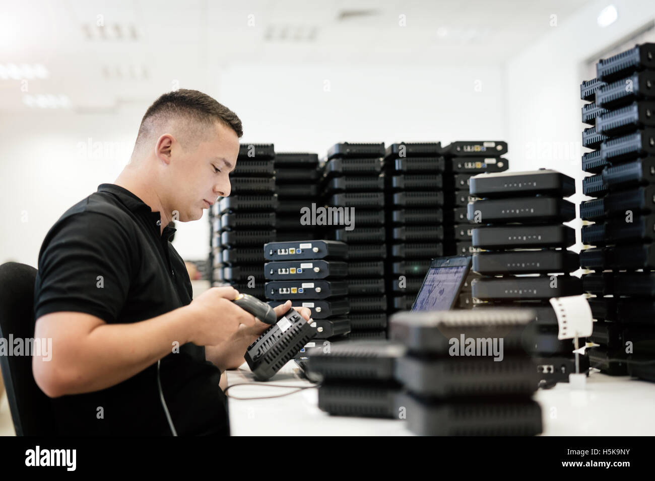 Worker using barcode reader to identify product Stock Photo - Alamy