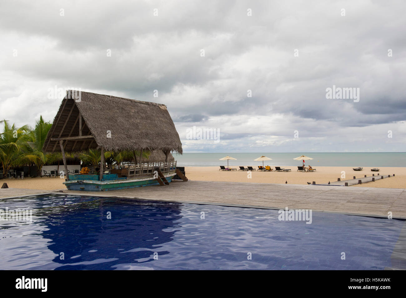 Resort swimming pool in front of a sandy beach in Passikudah Bay, Sri ...