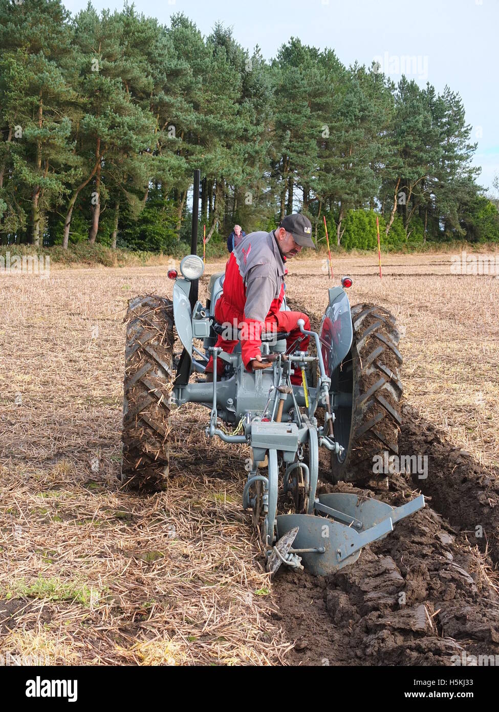 Farmer inspecting furrow at Ashover Ploughing Match, held at ...