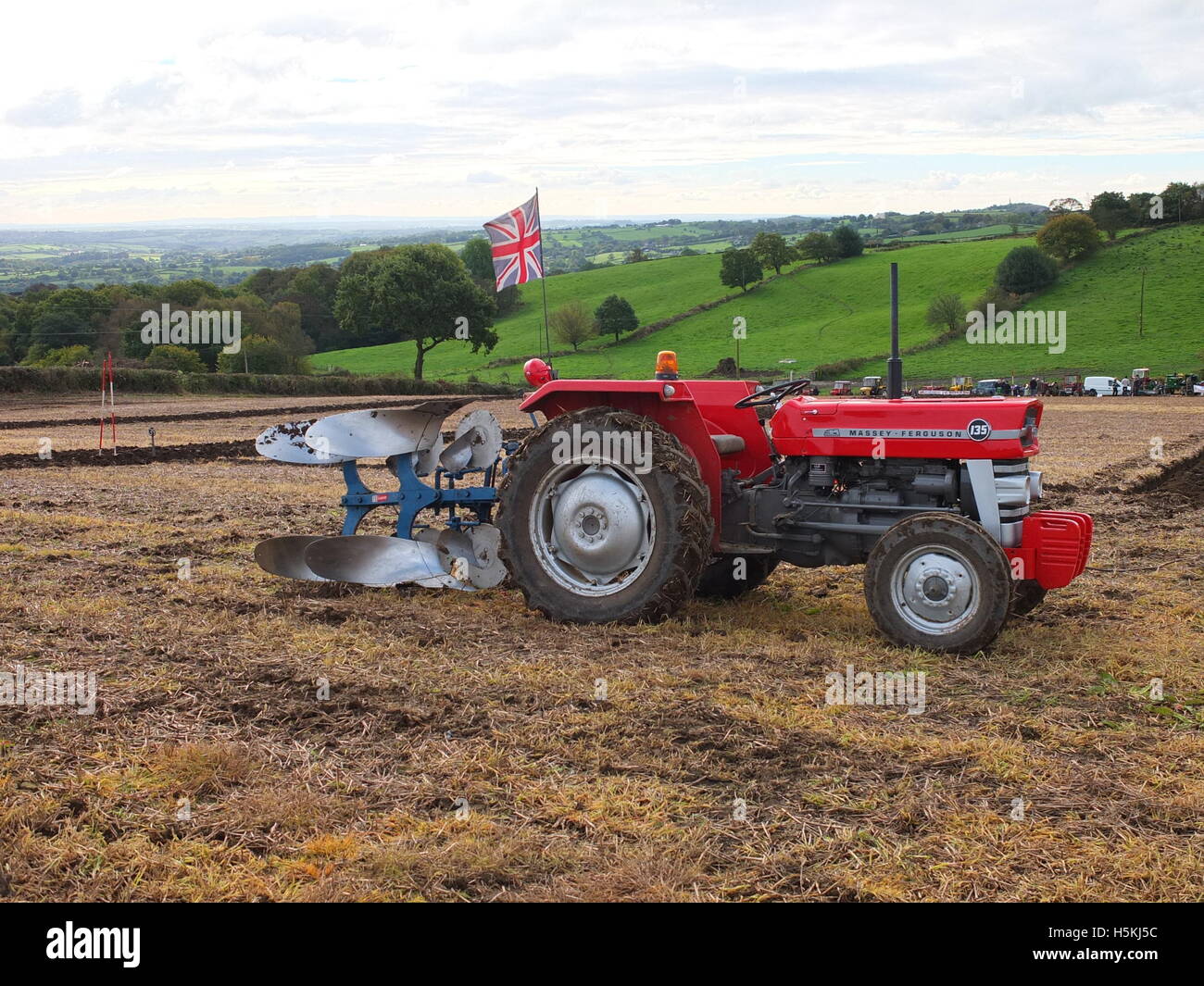 Tractor flying Union Jack flag on a farm with rolling Derbyshire ...