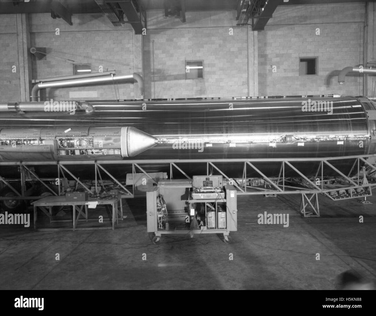 A photograph from the Atlas Collection showing a missile being loaded ...