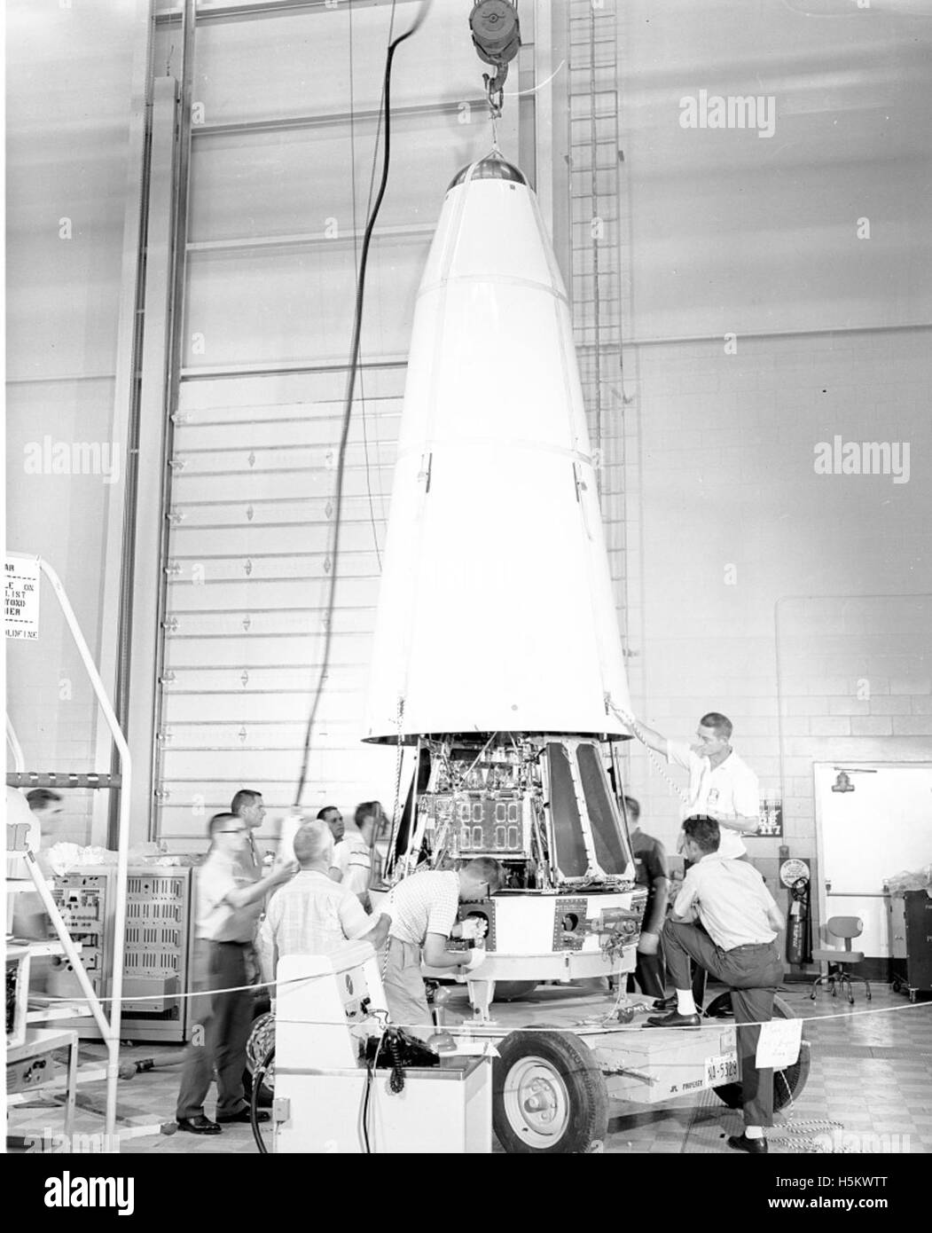 Photograph of the Atlas 111D rocket with the shroud being lowered onto ...