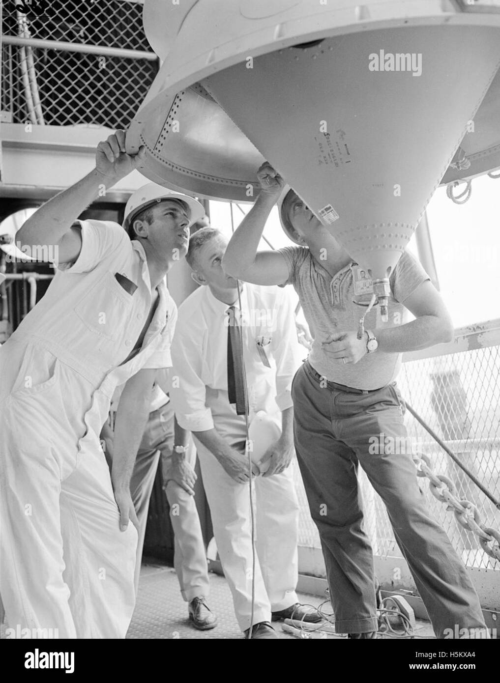 A photograph showing the process of mating the nose cone to the Atlas ...