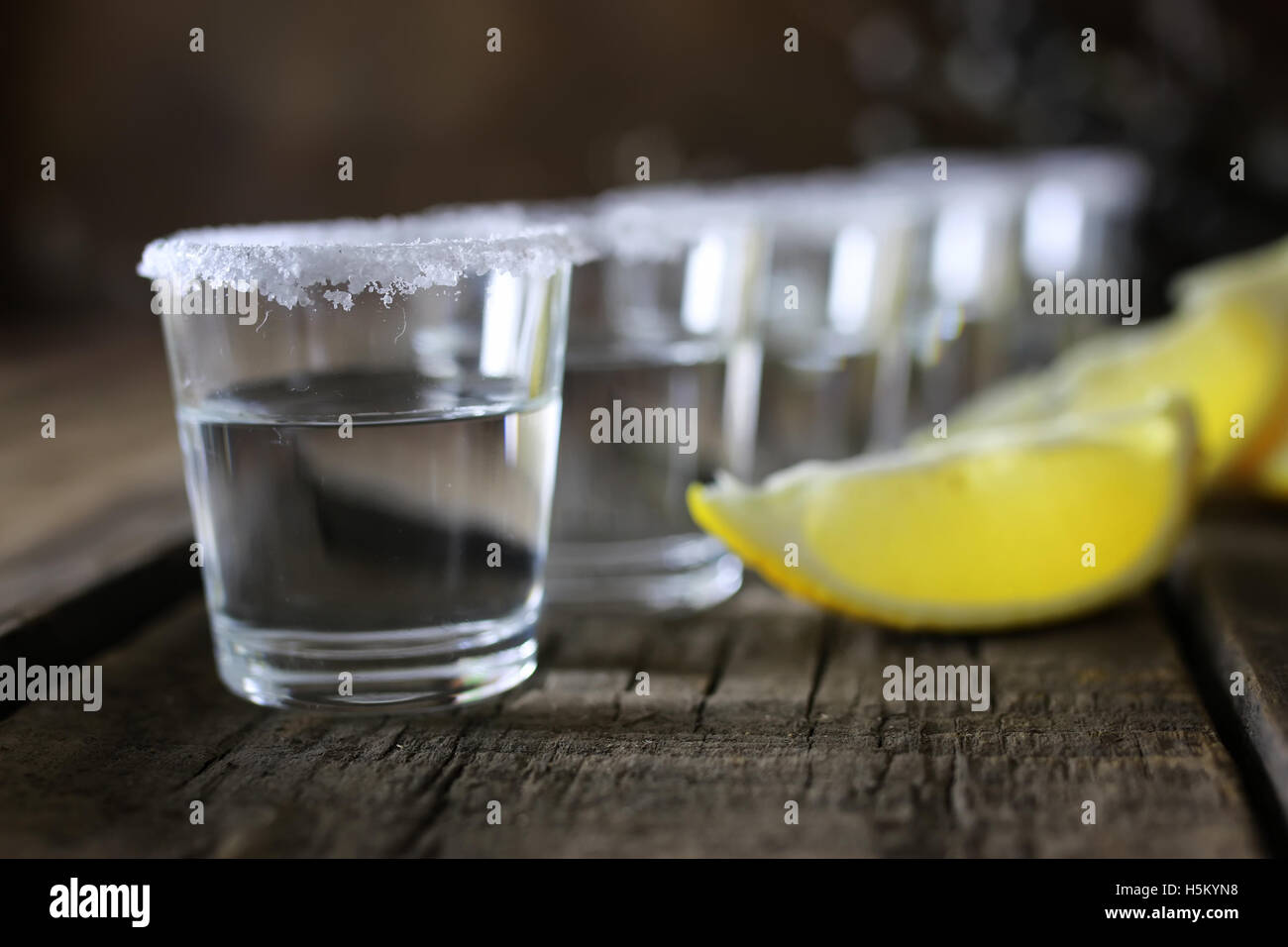 stack of tequila with salt and lemon on a wooden background Stock Photo ...