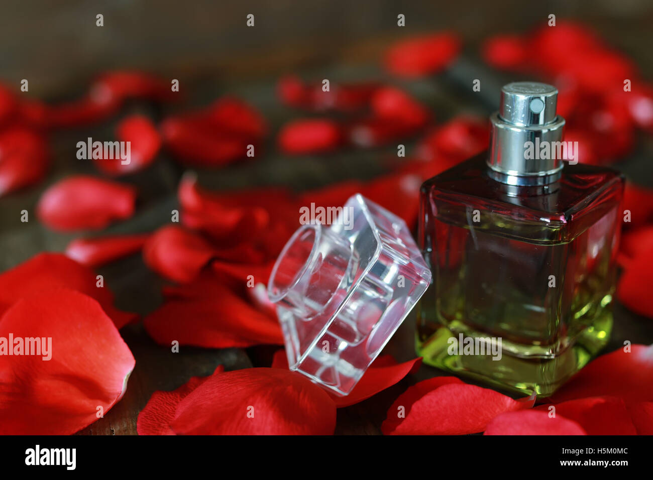 perfume bottle and petals Stock Photo - Alamy
