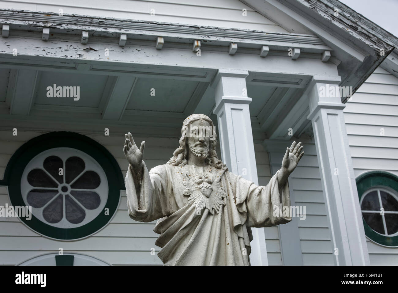 Statue of St Patrick outside a catholic church built of wood and ...