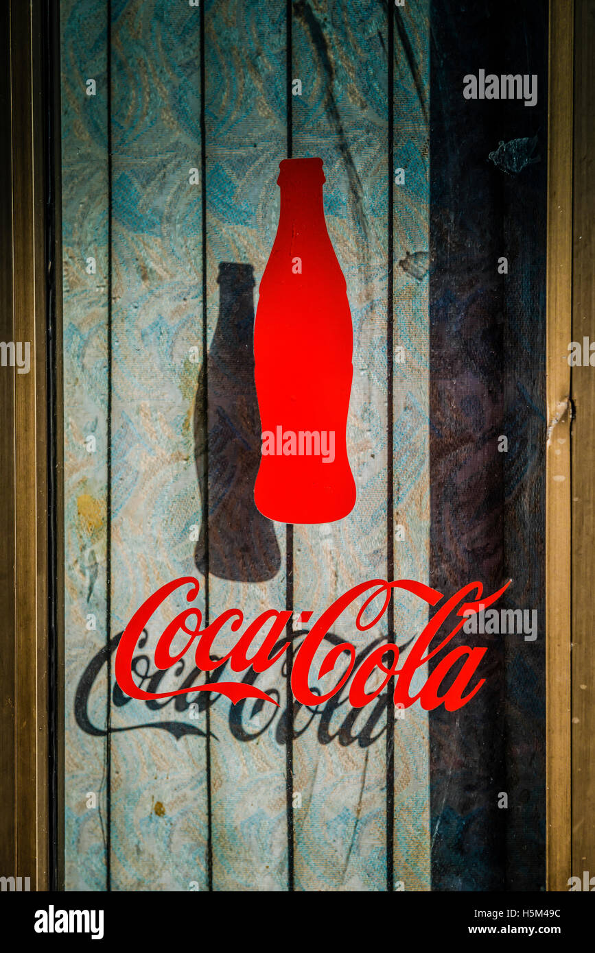 Red coca-cola shop window sign in derelict building Stock Photo - Alamy