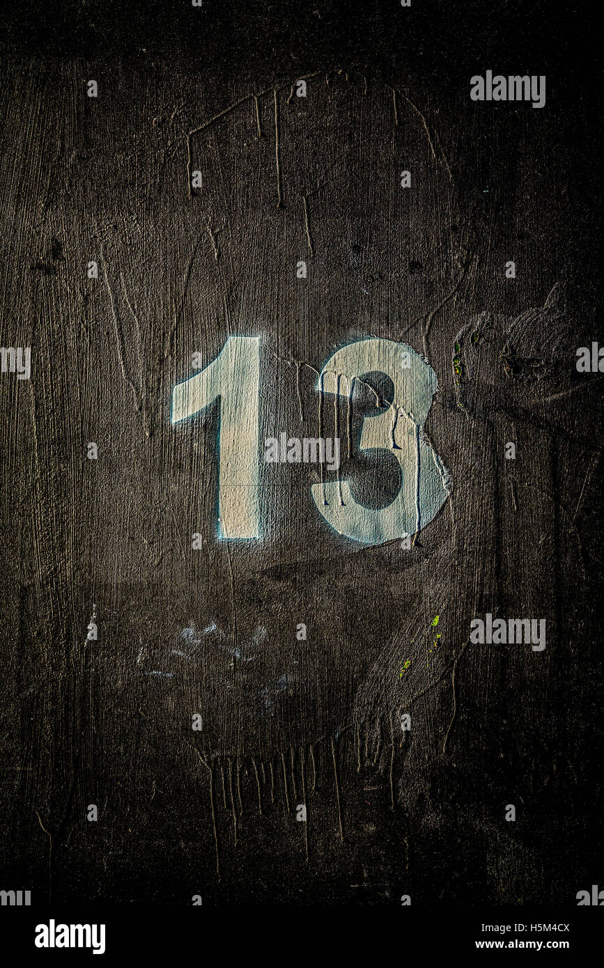 White number 13 on textured black sign Stock Photo - Alamy