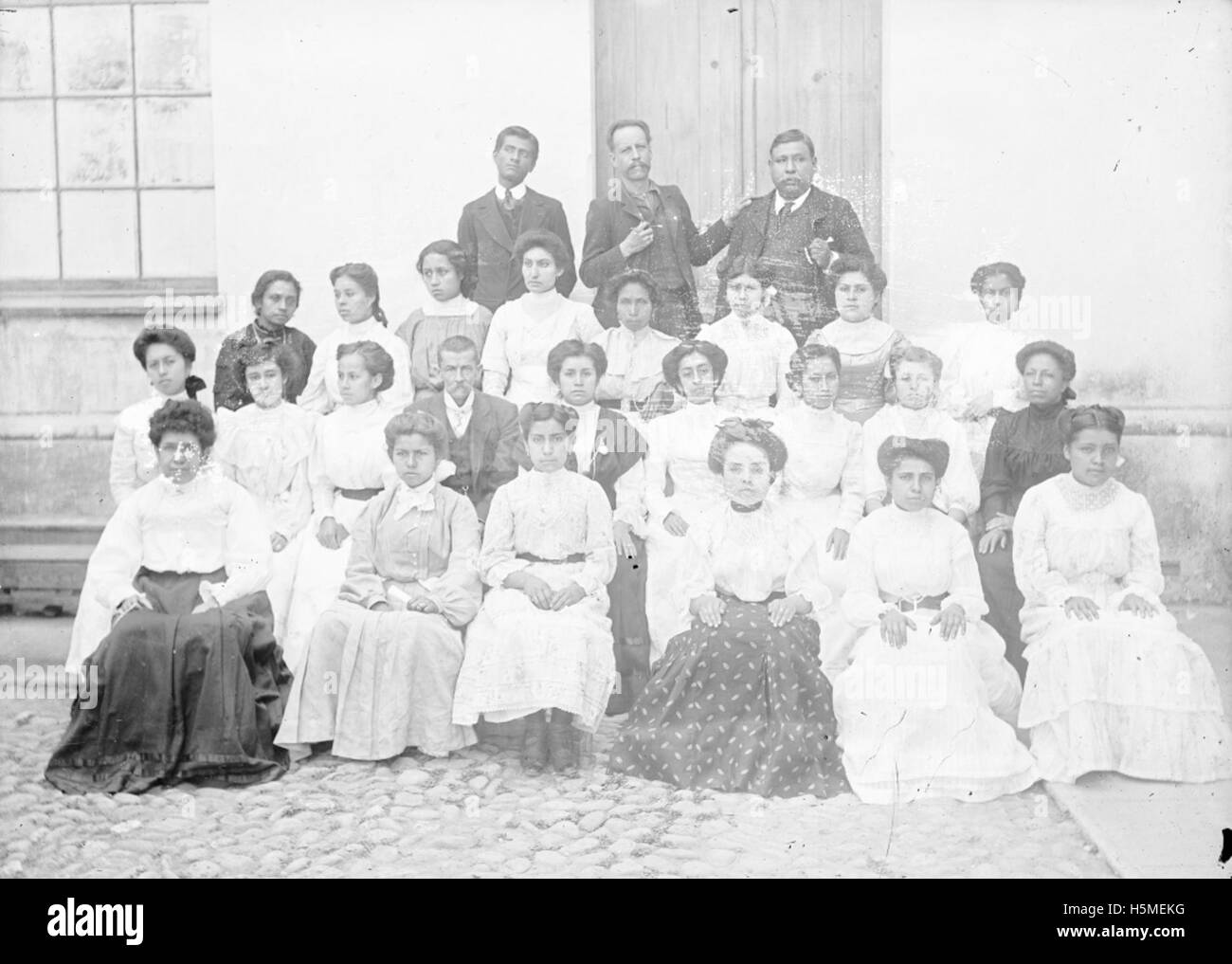 A historical group portrait depicting men and women involved in the ...