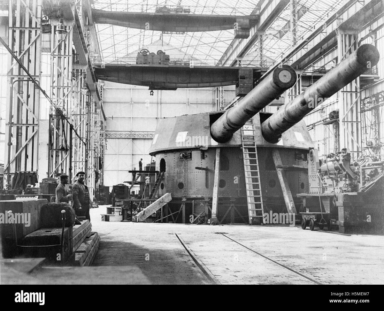The photograph shows a naval gun mounting at Elswick Works, a major ...