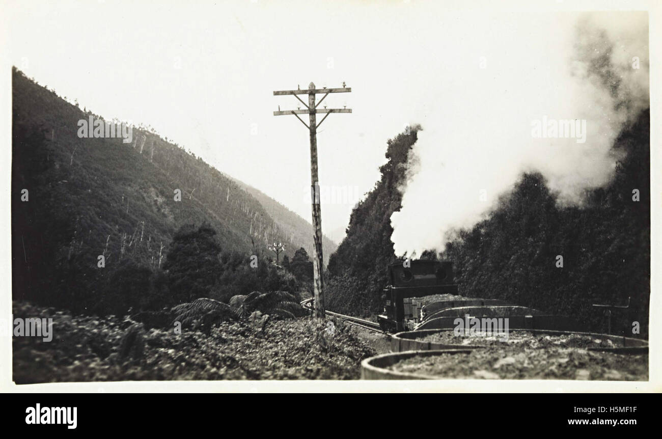 This photograph depicts a steam engine on track in 1947, towing round ...
