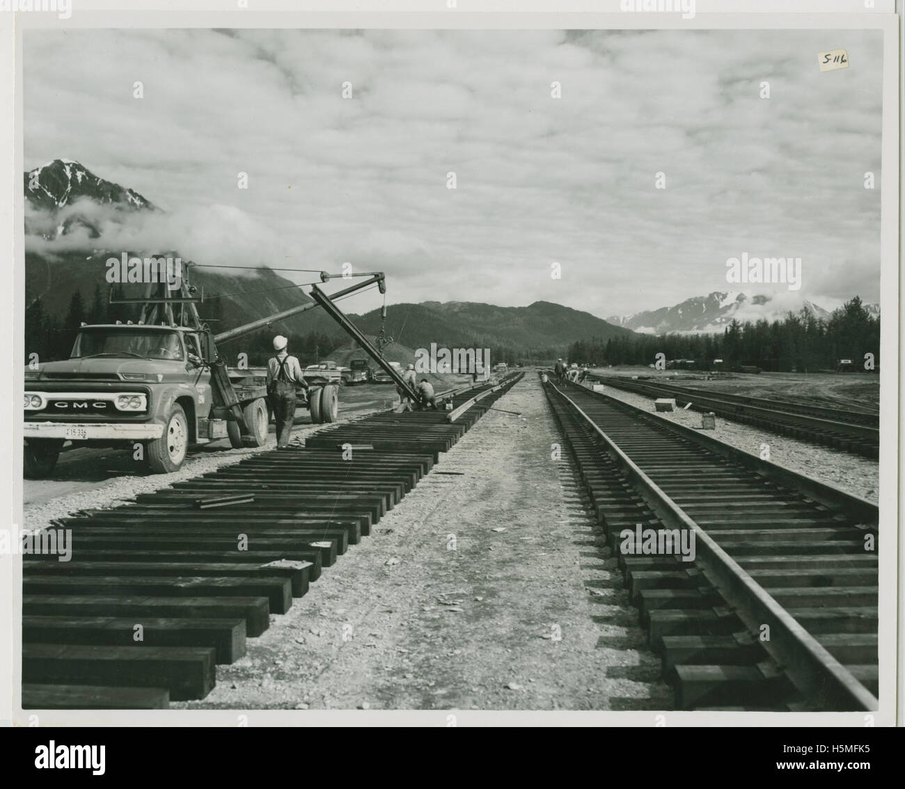 This image shows a reconstruction crew laying railway tracks on the ...