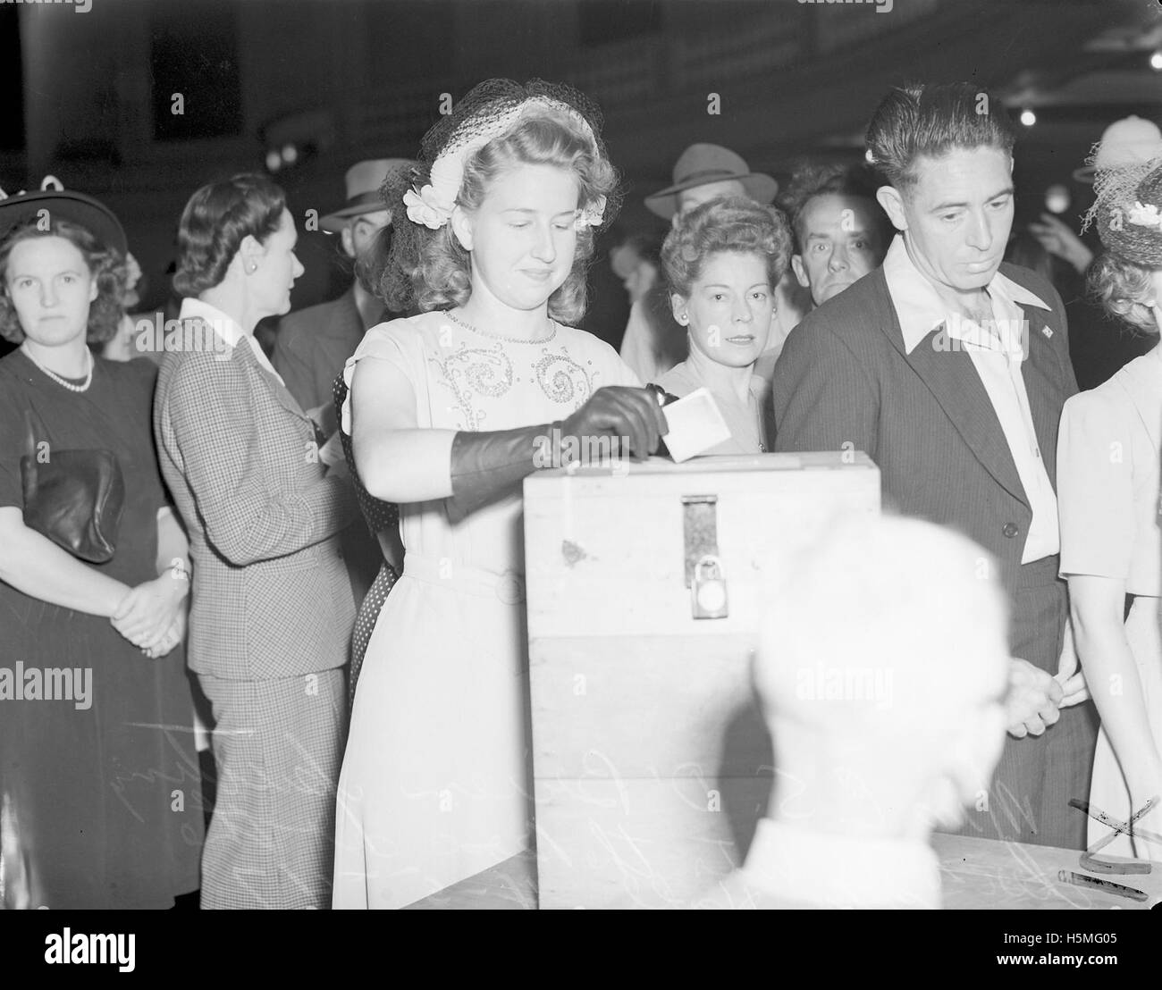 Miss E S O'Brien is shown casting her vote in a historical election ...
