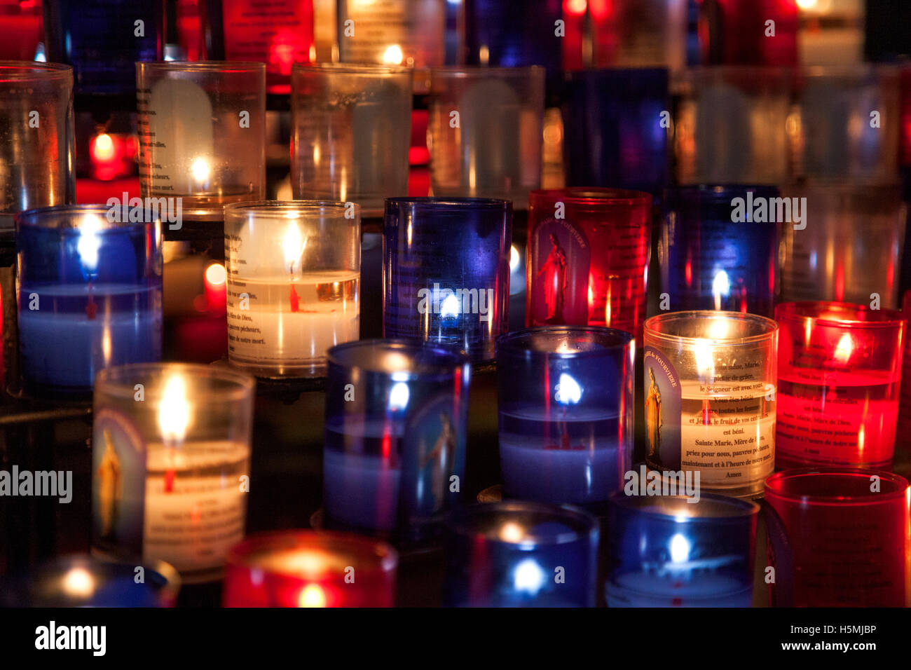 Votive candles lit in a church Stock Photo - Alamy