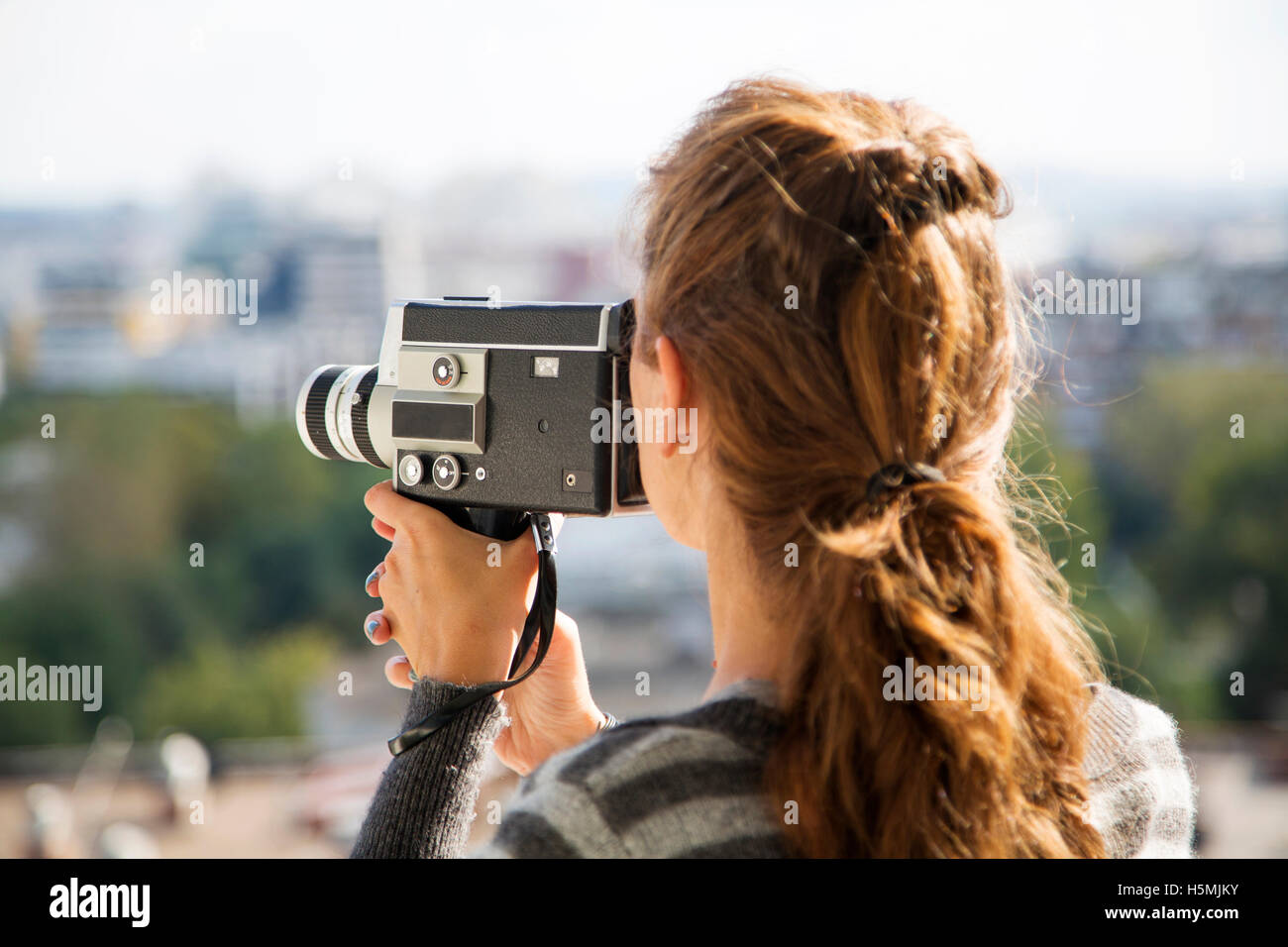Young woman filming with vintage motion camera Stock Photo - Alamy