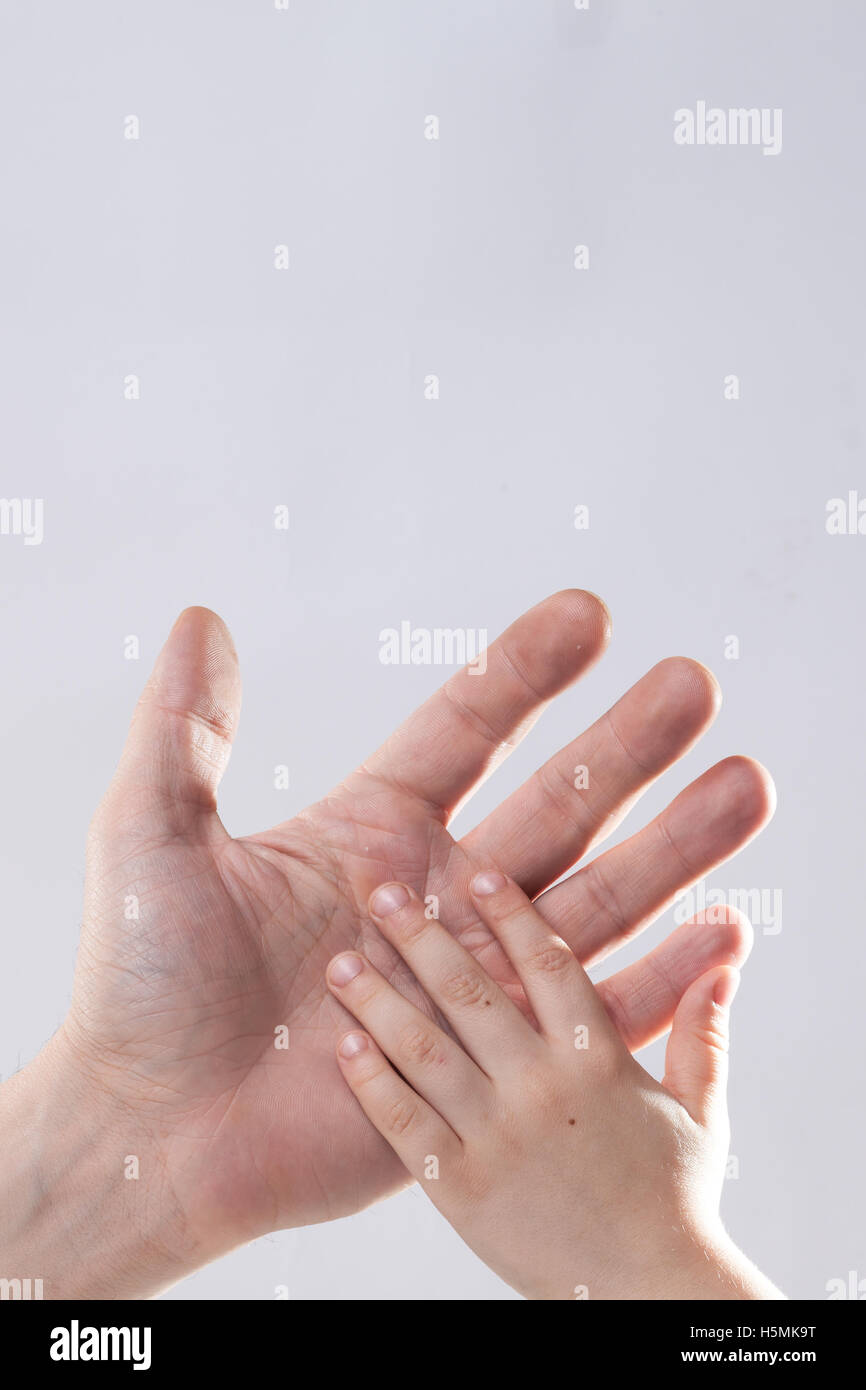 Adult hands hold childs hand hi-res stock photography and images - Alamy