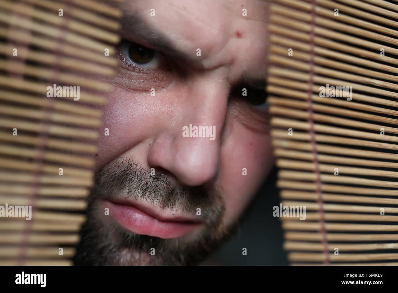 angry man at the jalousie Stock Photo - Alamy