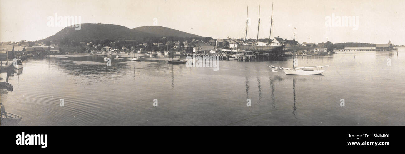 A photograph of Camden Harbor in Camden, Maine, showcasing a sailboat ...