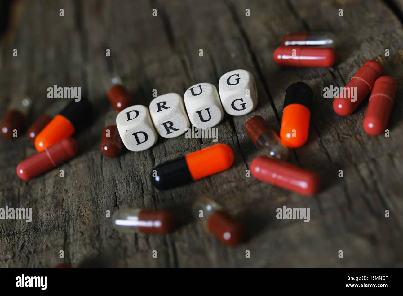 drug pill on wooden table concept addiction Stock Photo - Alamy