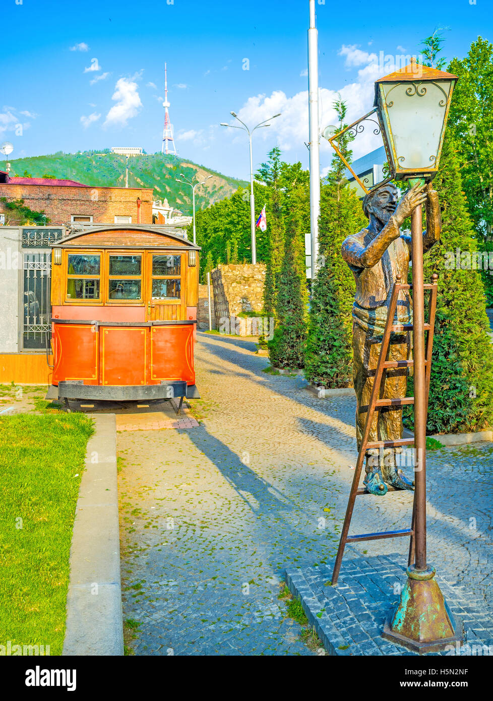 The statue of old lamplighter, fixing the streetlight, and the vintage ...