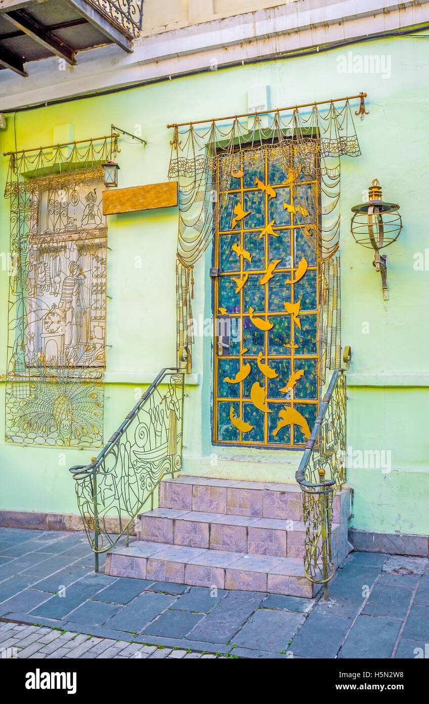 The house entrance and the window decorated with the curtains and tulle ...