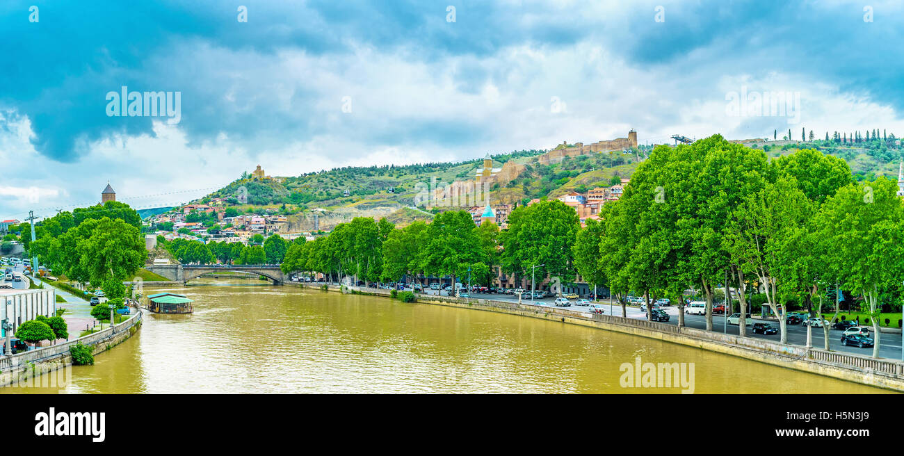 The Kura River surrounded by green trees, hiding the city landmarks ...