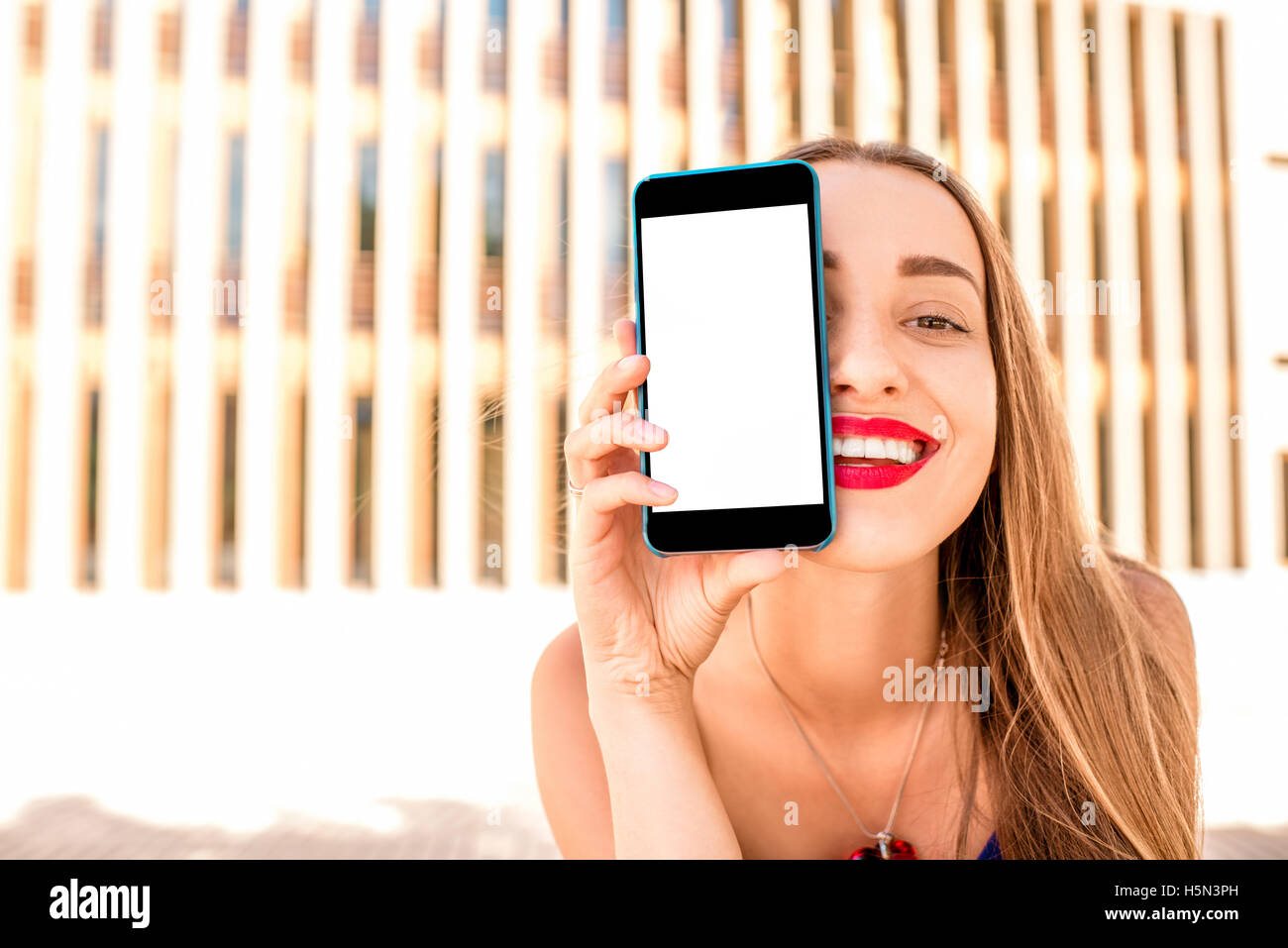 Woman's face with phone outdoors Stock Photo - Alamy