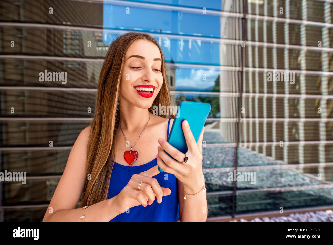 Woman with phone outdoors Stock Photo - Alamy