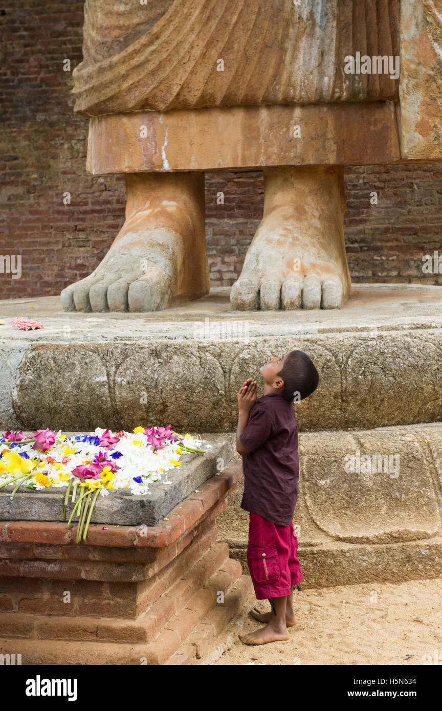 Boy praying at the God Naatha statue (God Avalokitesvara), 10 meters ...