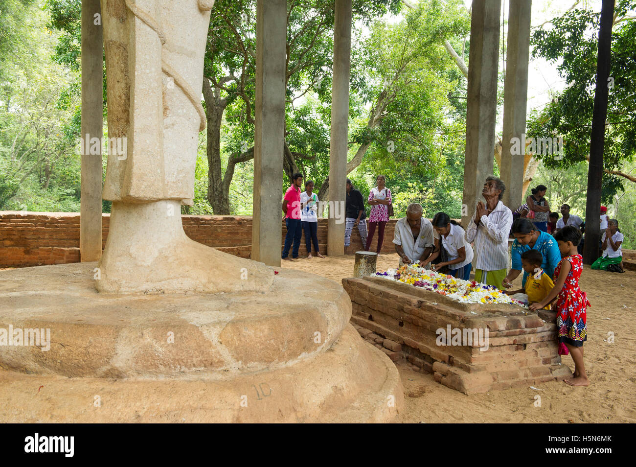 Pilgrims bringing offerings to the God Naatha statue (God ...