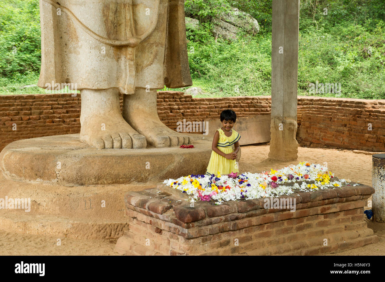 Girl at the God Naatha statue (God Avalokitesvara), 10 meters high ...