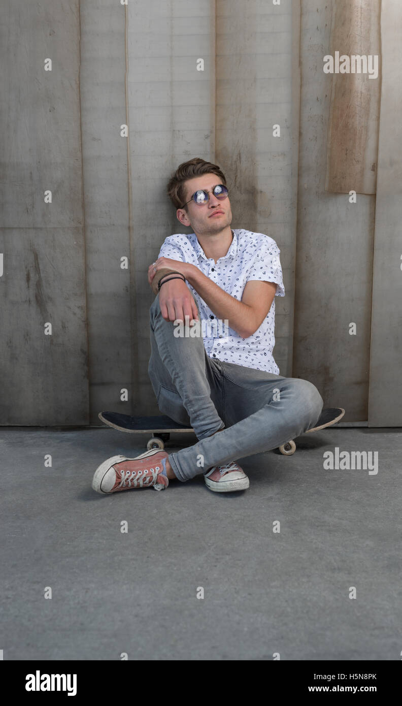 fashionable guy with skateboard Stock Photo - Alamy