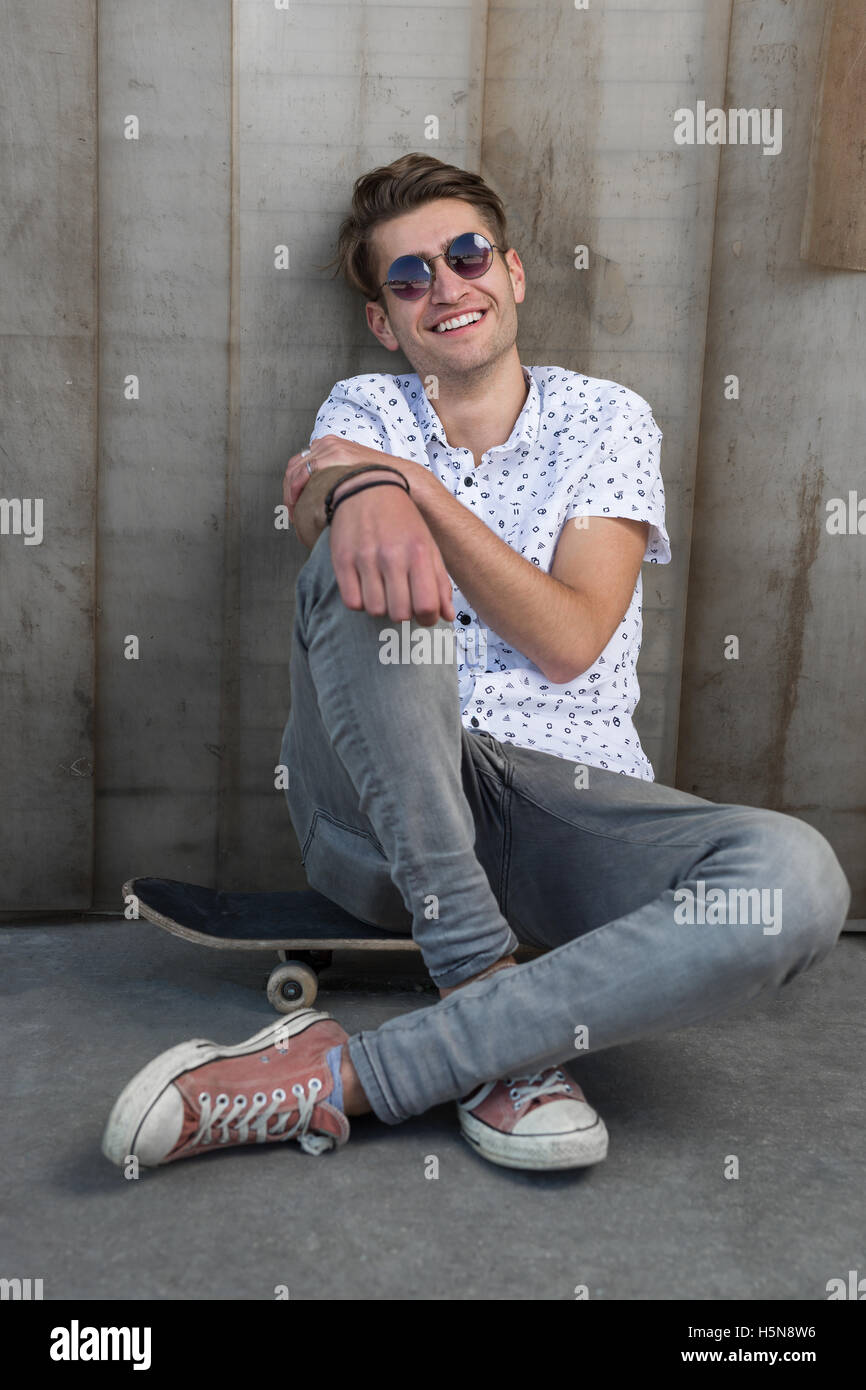 fashionable guy with skateboard Stock Photo - Alamy