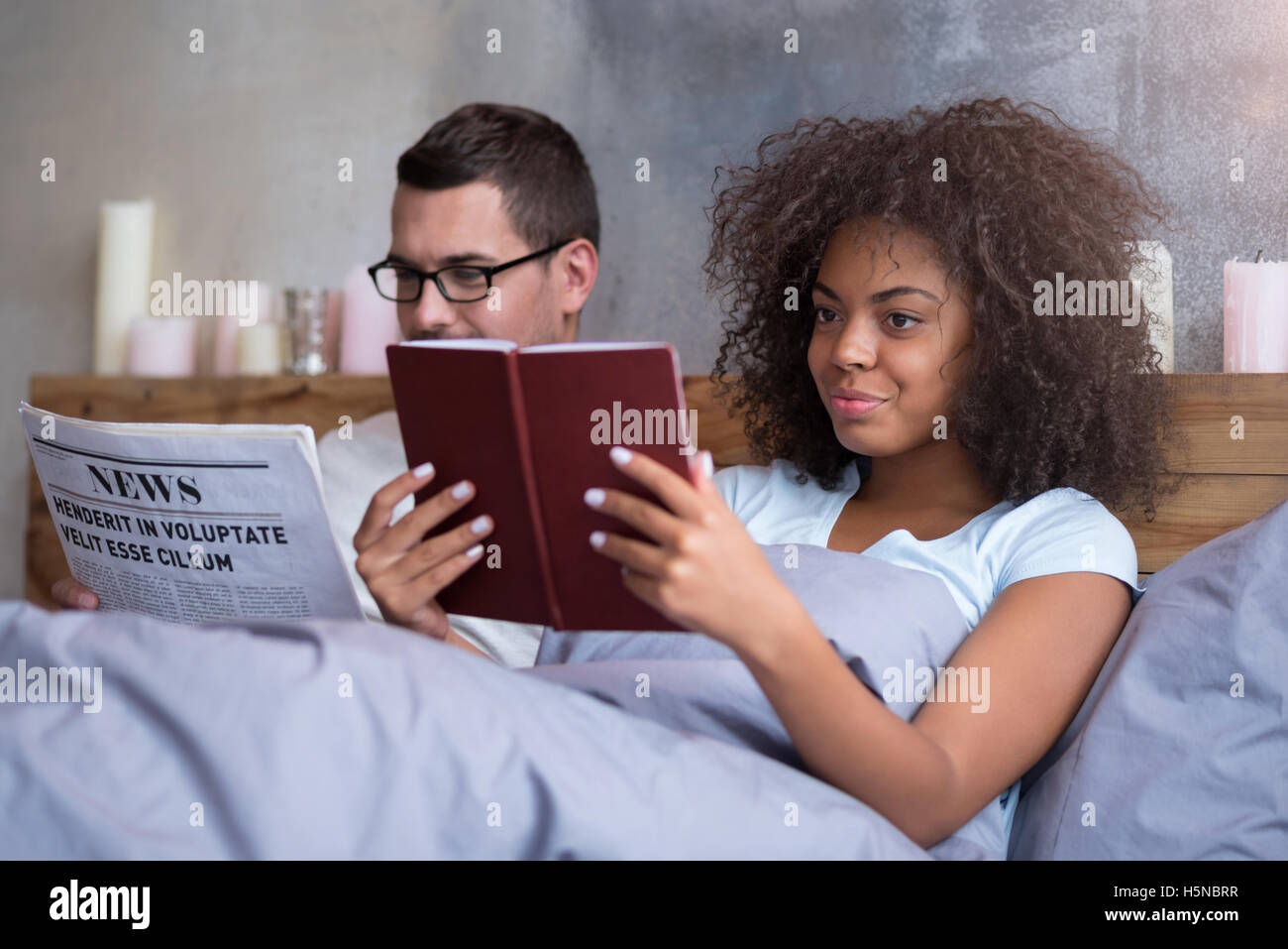 Young couple reading in bed together Stock Photo - Alamy