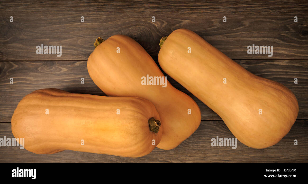 Three large butternut squash against wood background Stock Photo - Alamy