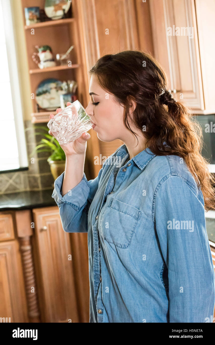 Young adult drinking water Stock Photo - Alamy