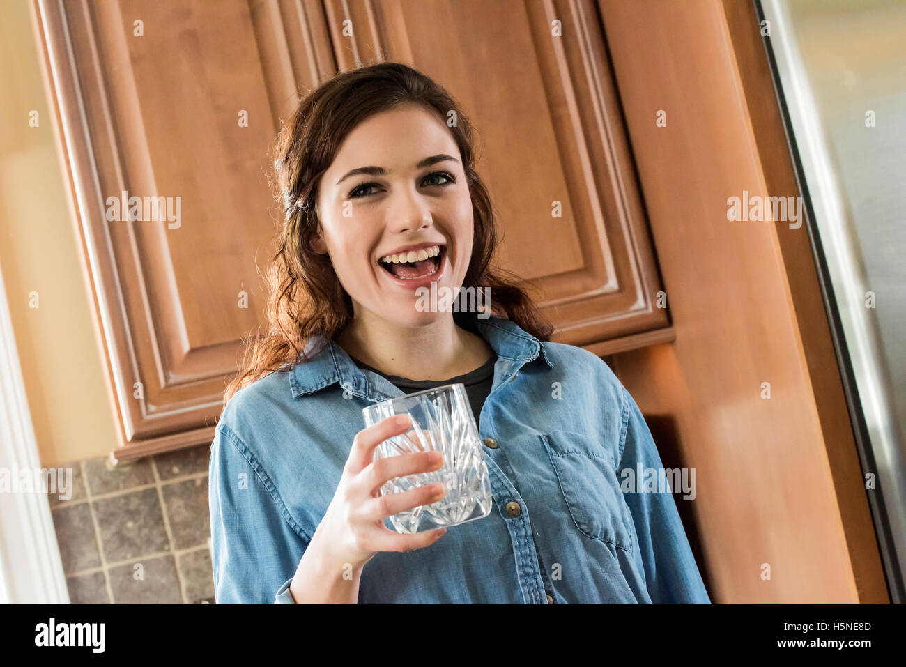 Young adult drinking water Stock Photo - Alamy
