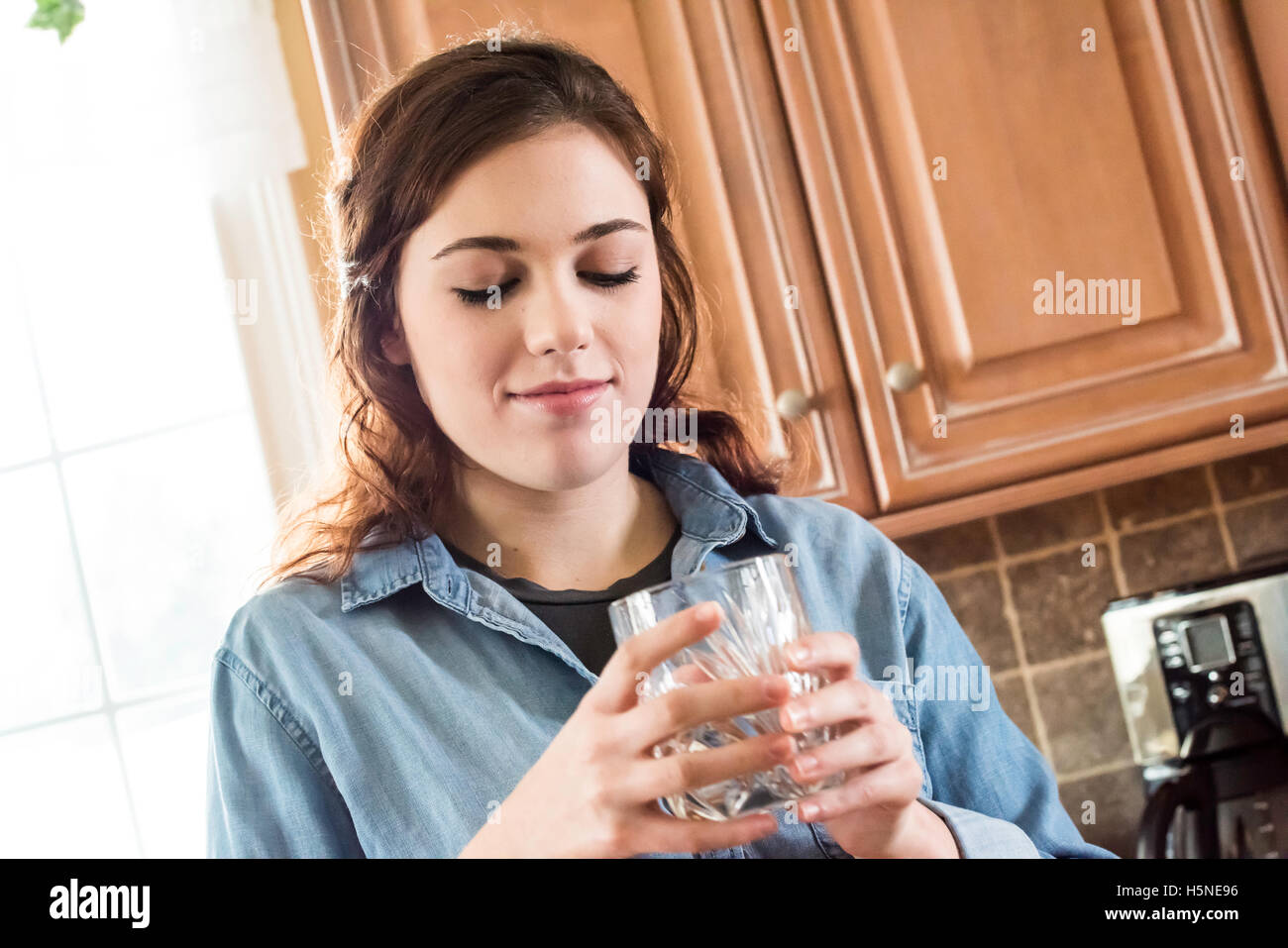 Young adult drinking water Stock Photo - Alamy