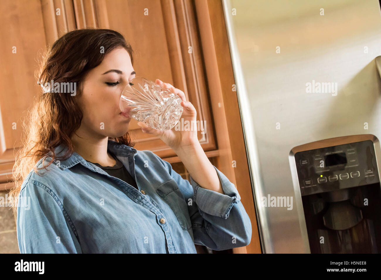 Young adult drinking water Stock Photo - Alamy