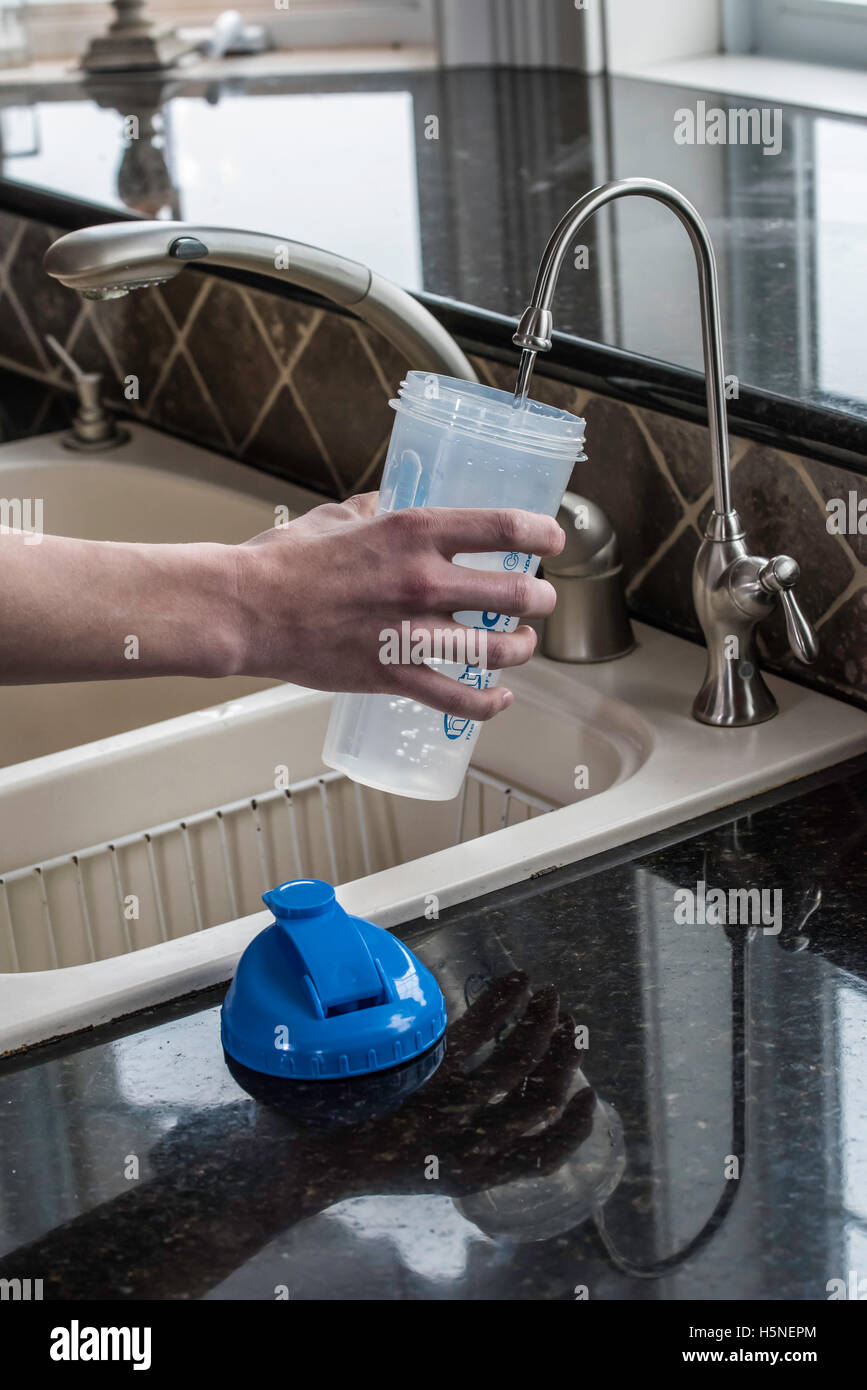 Young adult drinking water Stock Photo - Alamy