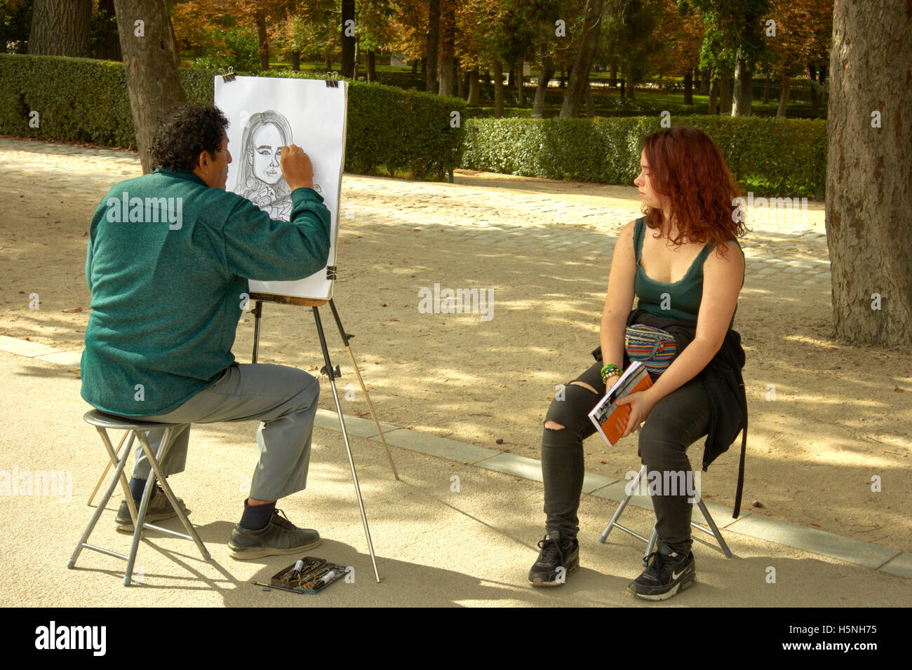 Street painter doing a portrait in the Retiro Park. Madrid. Spain Stock ...
