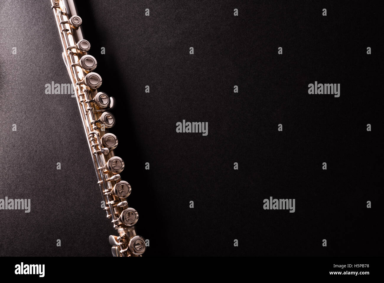 Detail of transverse flute on black table. Horizontal composition. Top ...
