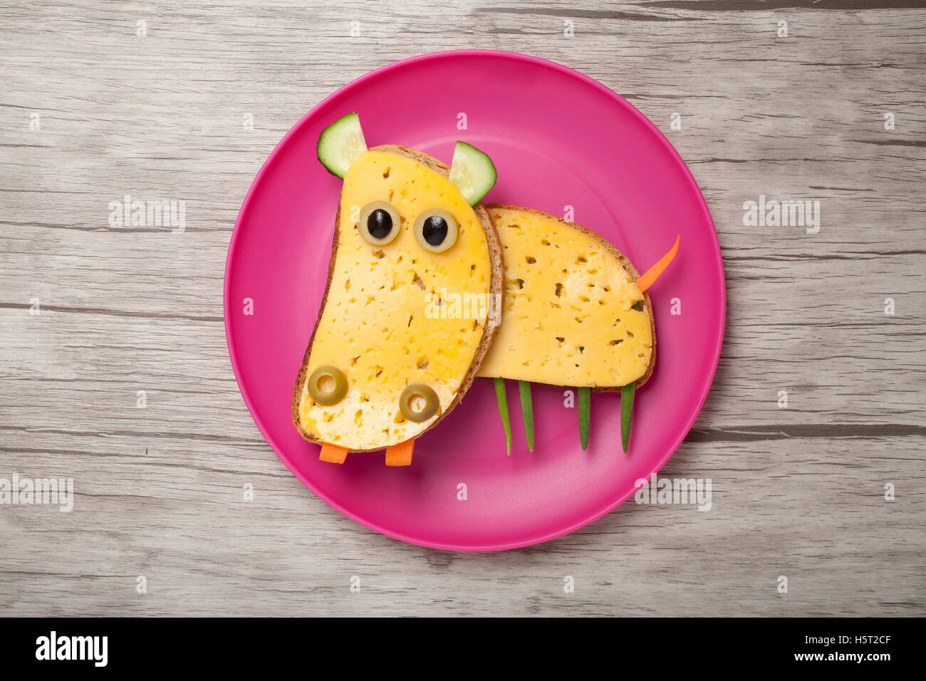Hippo made of cheese and bread on plate and board Stock Photo - Alamy