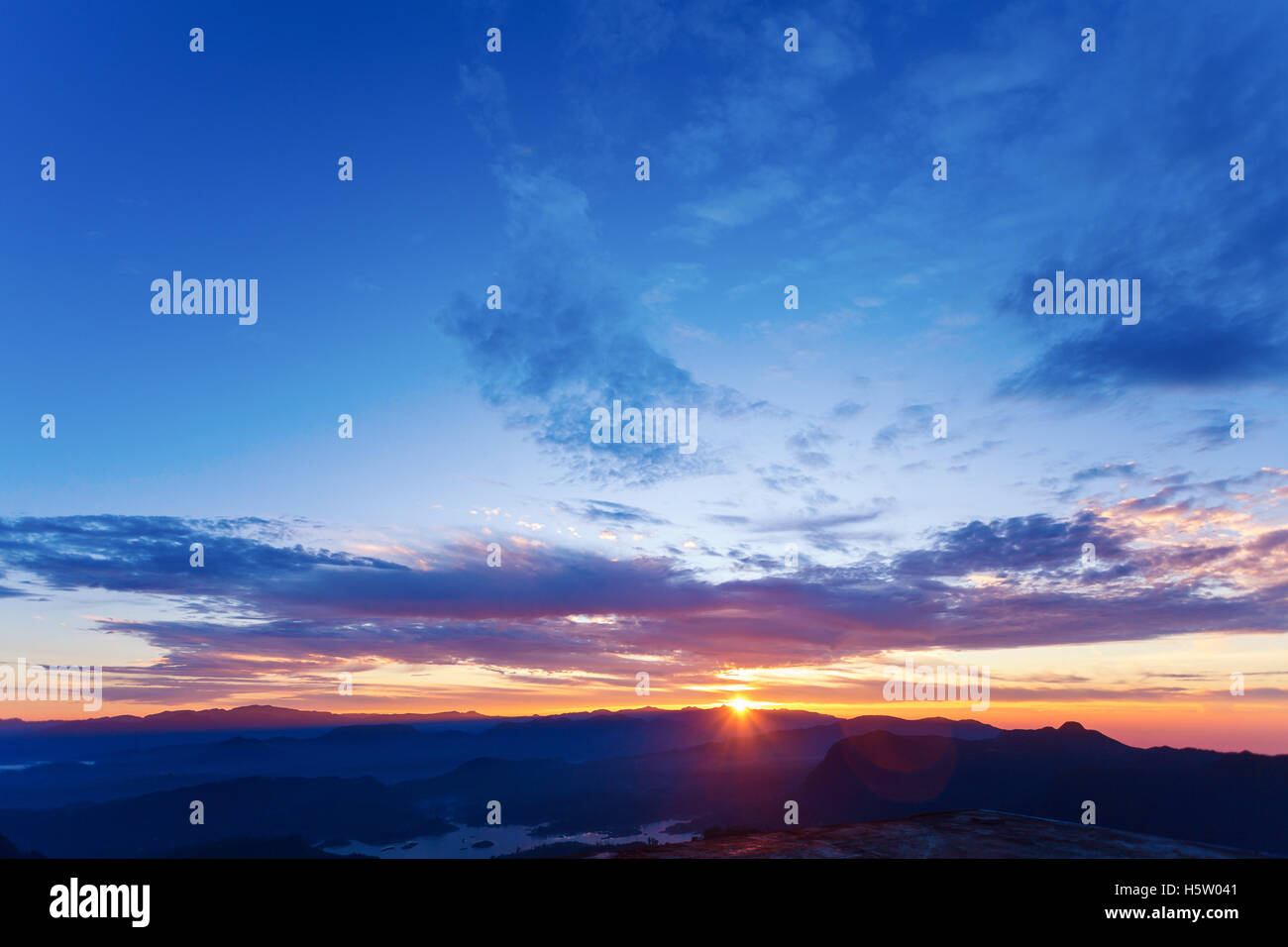 Sunrise at mountains Stock Photo - Alamy