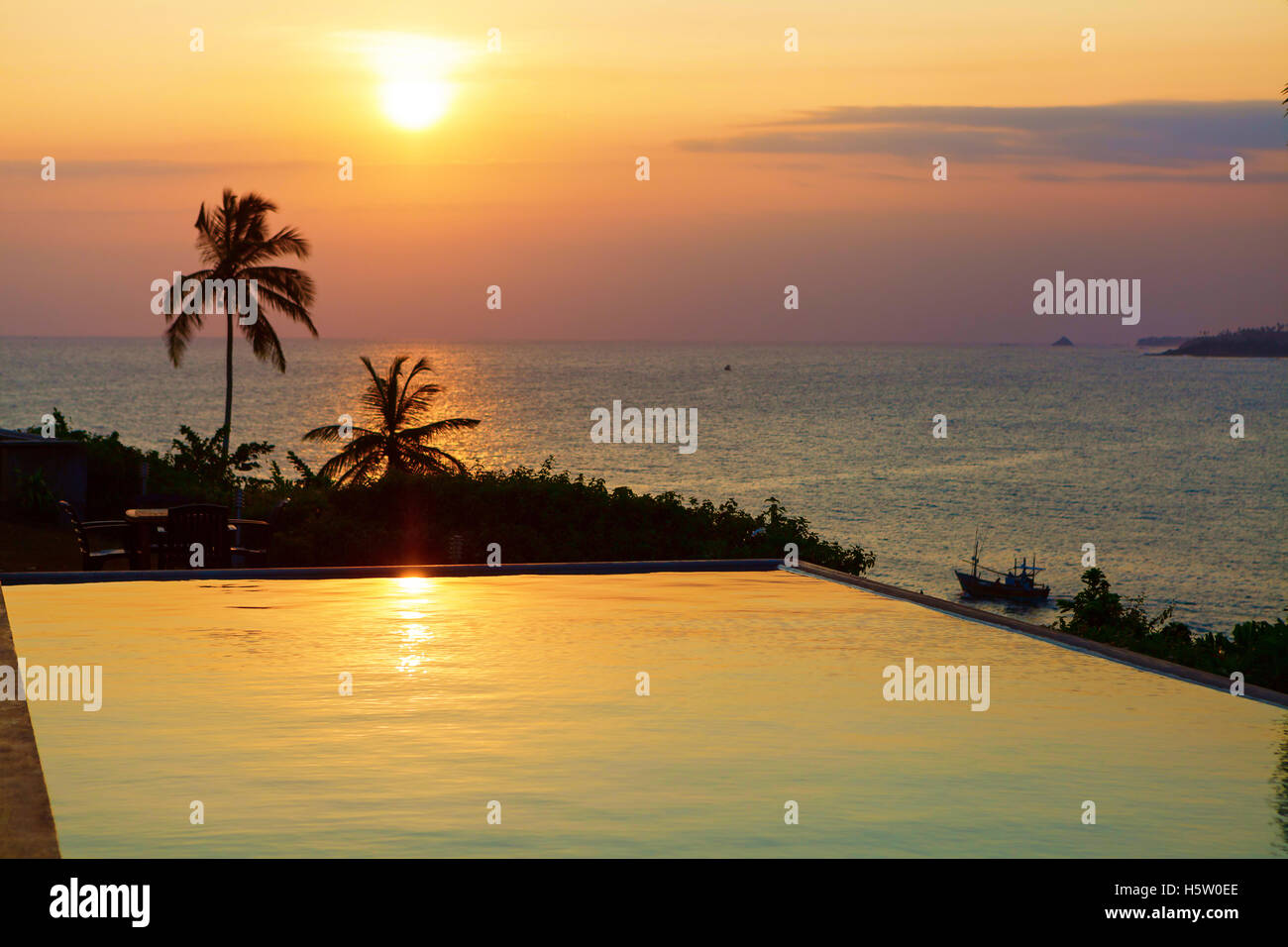 Romantic sunset at pool and sea Stock Photo - Alamy