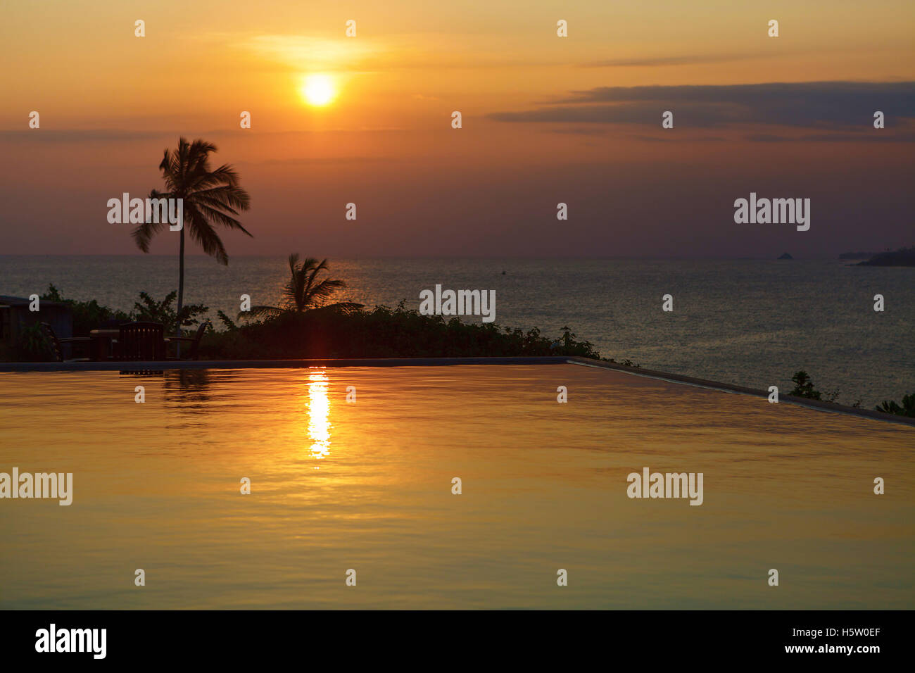 Romantic sunset at pool and sea Stock Photo - Alamy