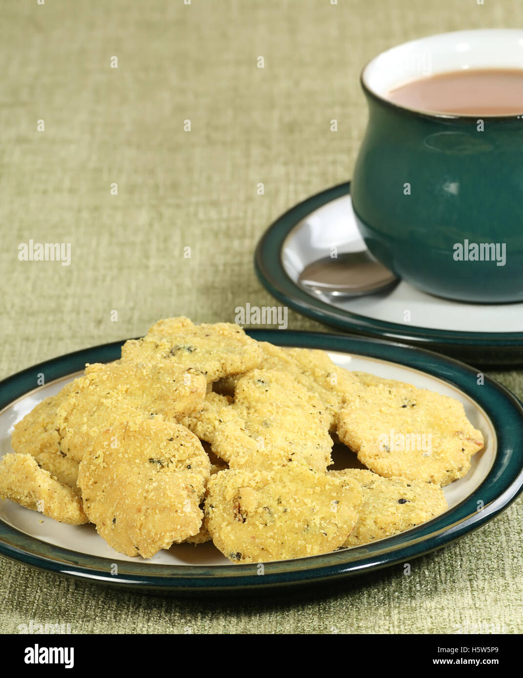 spicy fried mathri indian snack served with a cup of tea Stock Photo ...