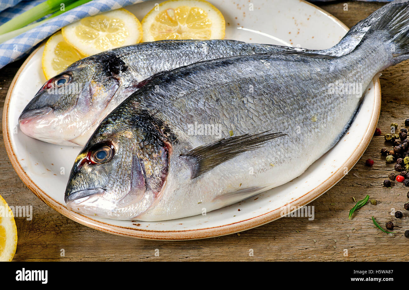 Raw fresh dorado fish on a plate Stock Photo - Alamy
