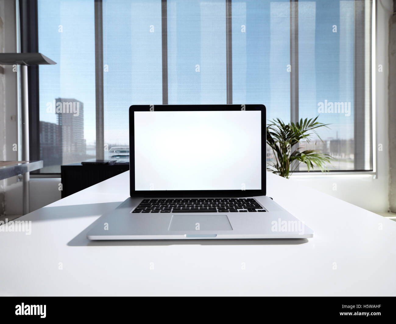 Computer in a office with window Stock Photo - Alamy